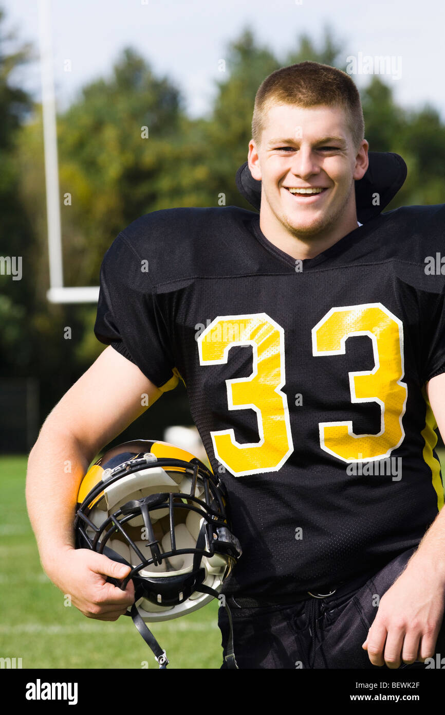 Cheerful football helmet player skill sports success walking hi-res ...