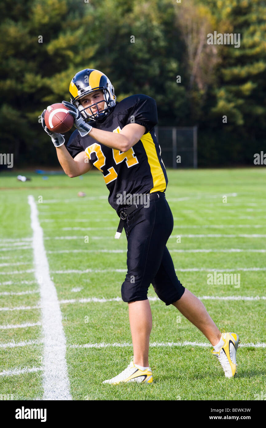 Football player playing in a field Stock Photo - Alamy