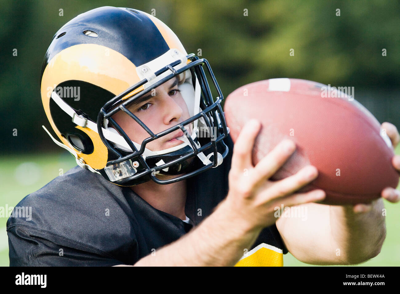 Football player playing in a field Stock Photo - Alamy