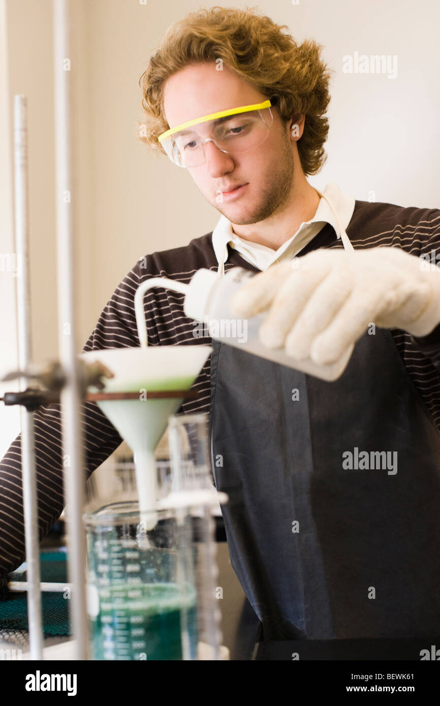 Student doing a scientific experiment in a laboratory Stock Photo - Alamy