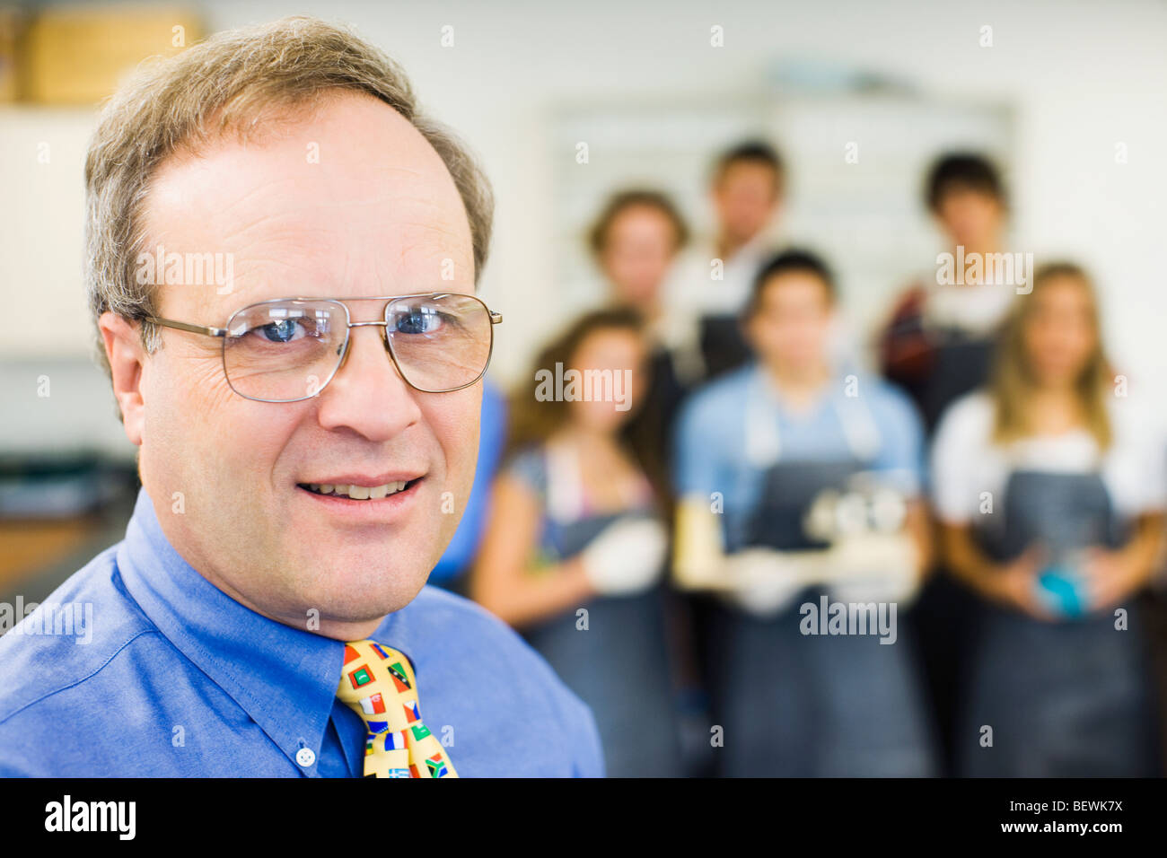 Professor smiling in a classroom Stock Photo - Alamy