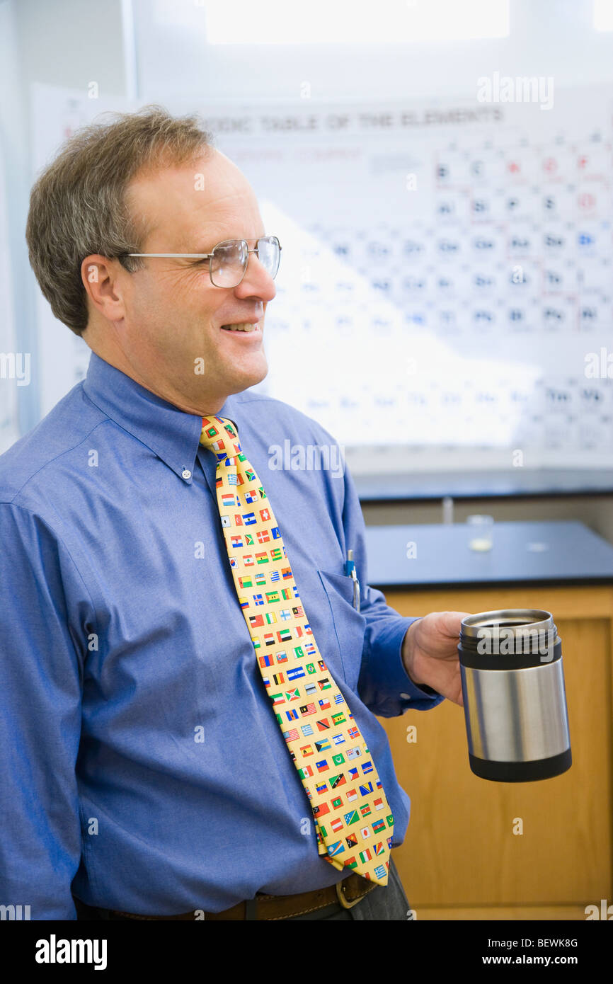 Professor holding an insulated coffee mug Stock Photo - Alamy