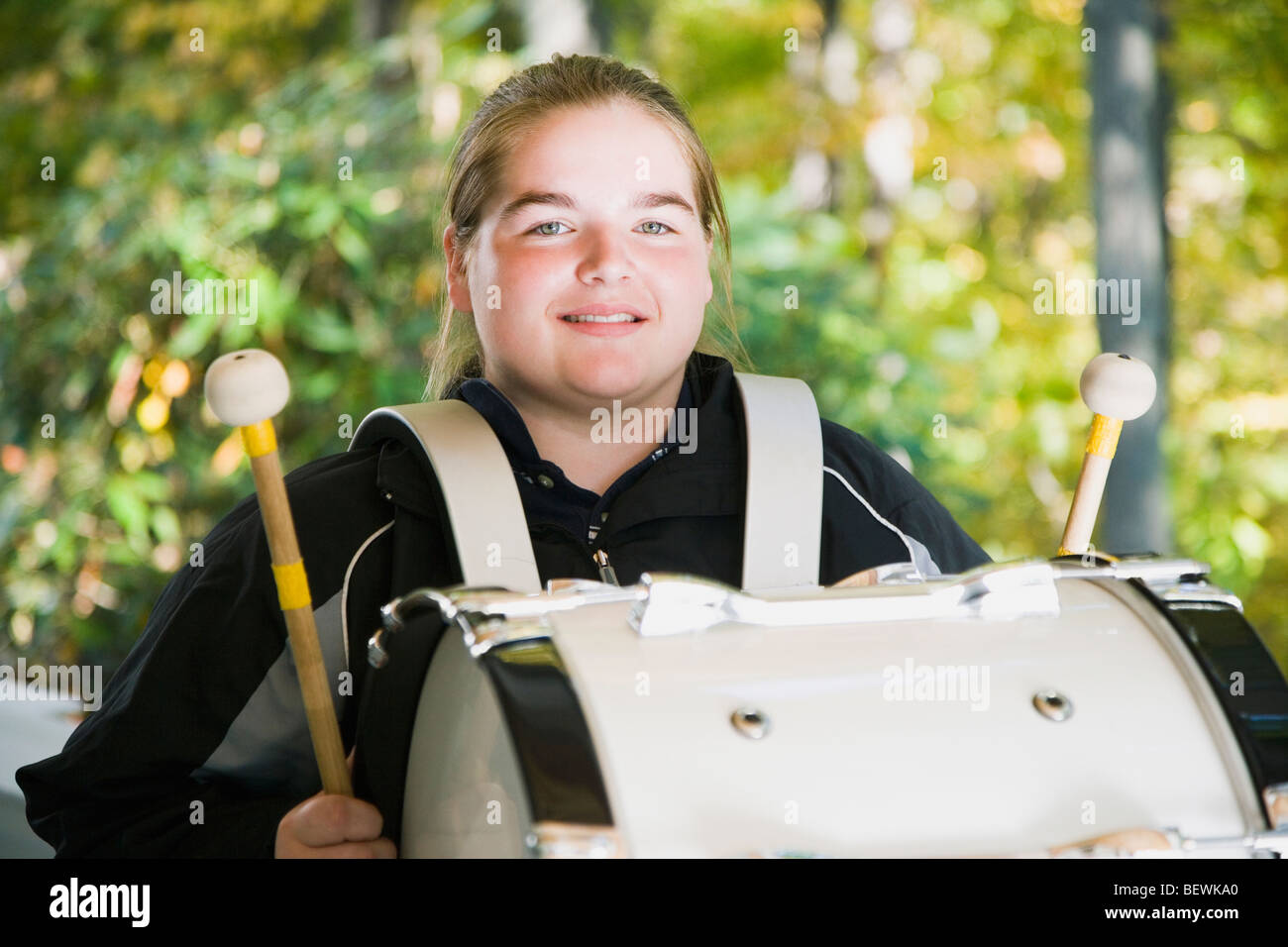Woman playing drum and smiling Stock Photo - Alamy
