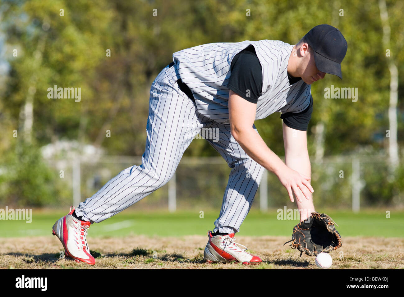 Man playing baseball Stock Photo - Alamy