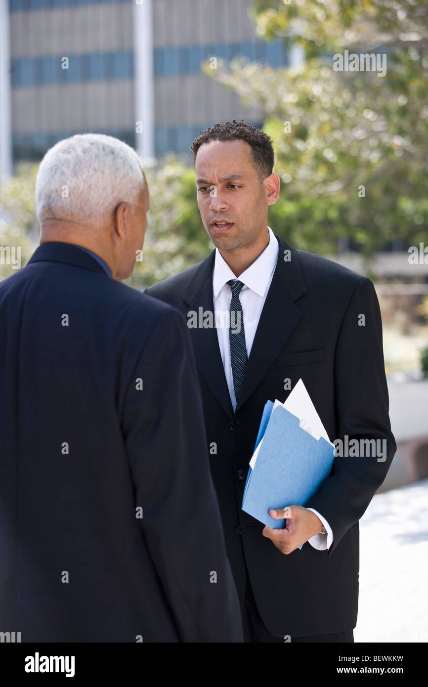 Two businessmen talking to each other Stock Photo - Alamy