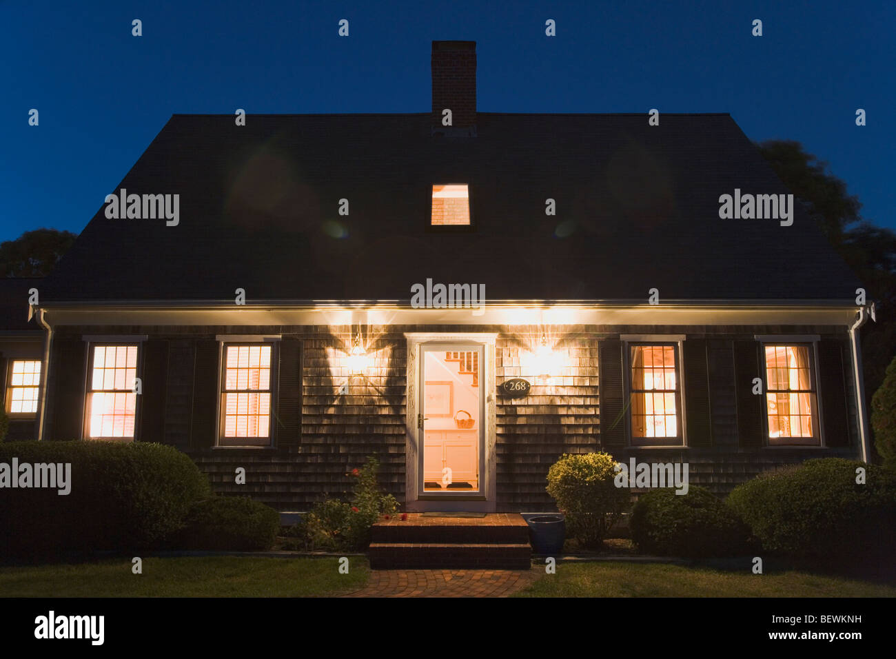House lit up at dusk Stock Photo - Alamy