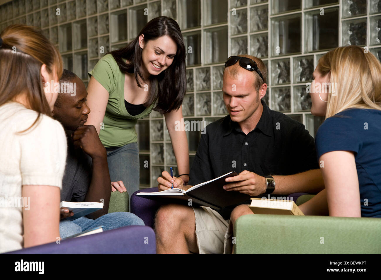 Group of young adults study together in a library Stock Photo - Alamy
