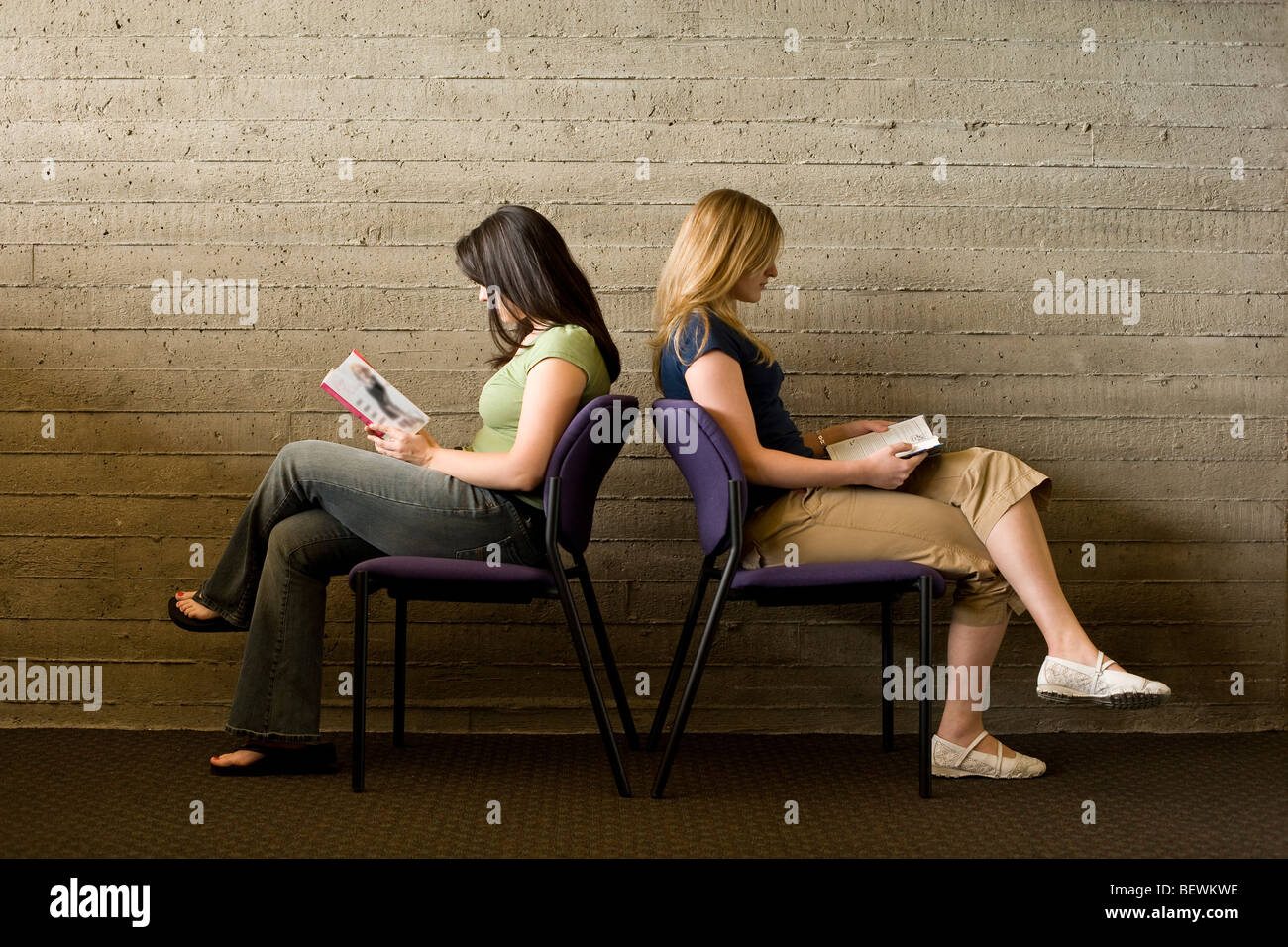 Young women reading in a library together Stock Photo - Alamy