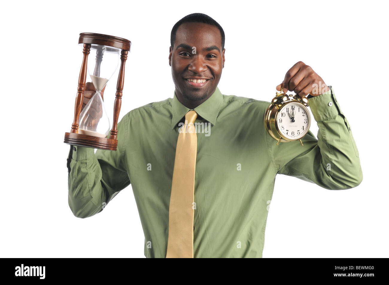 Businessman holding a sand timer and a vintage clock isolated on a ...