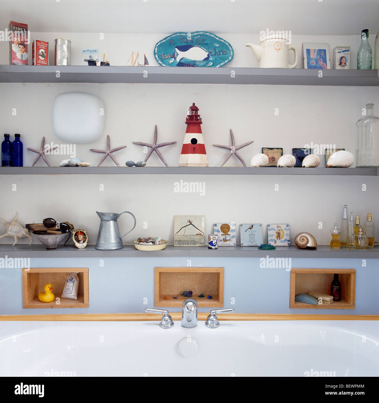 Collection of seashells and starfish on shelves above bath Stock Photo ...