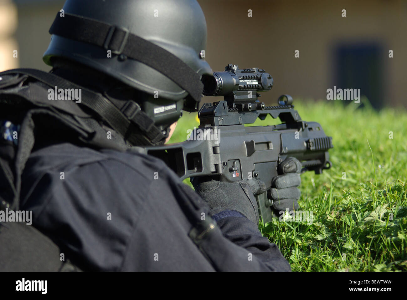 Police firearms officer in containment position Stock Photo - Alamy