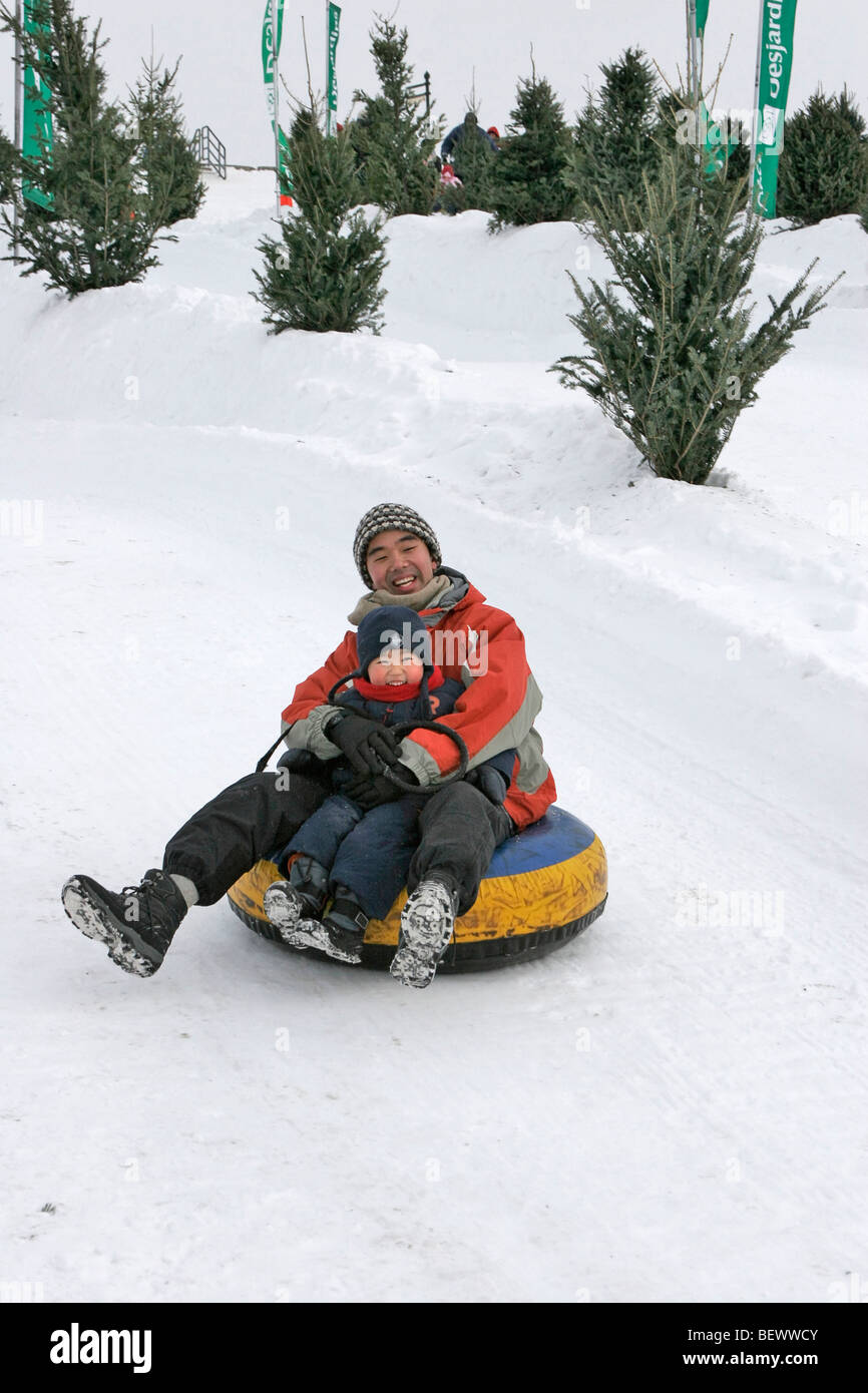 Sliding down tubing run at snow play park on Plains of Abraham during ...