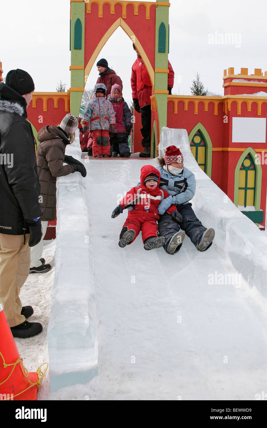 Children on ice slide at snow play area on Plains of Abraham at Quebec ...