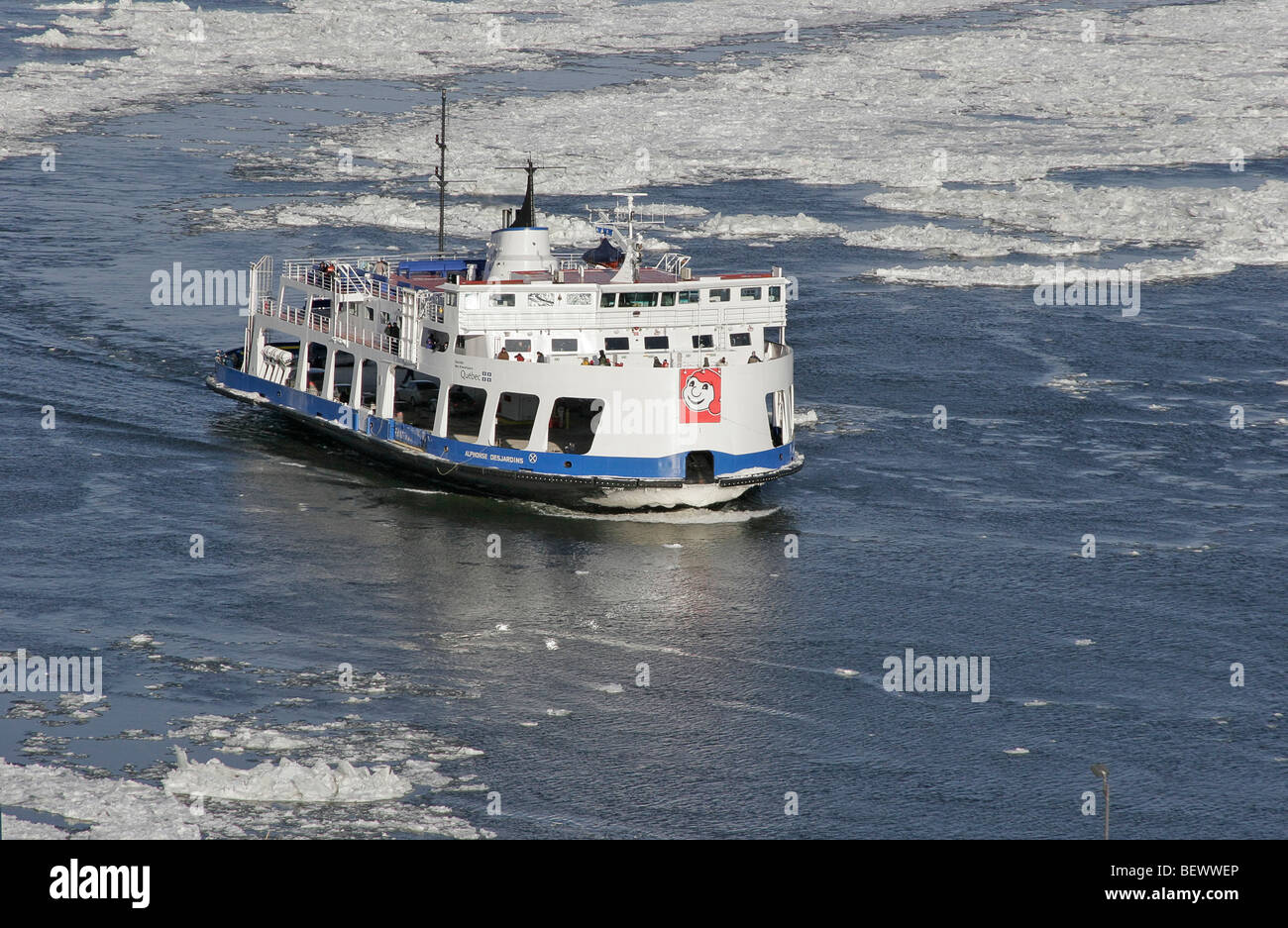 Ferry crosses partially frozen St. Lawrence River, viewed from Dufferin ...
