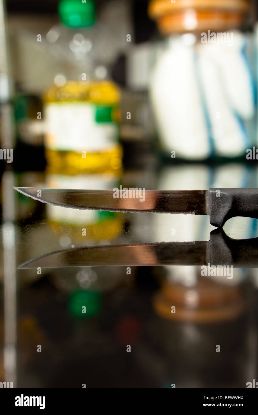 Old and Scratchy Knife with its reflection isolated by shallow depth of ...