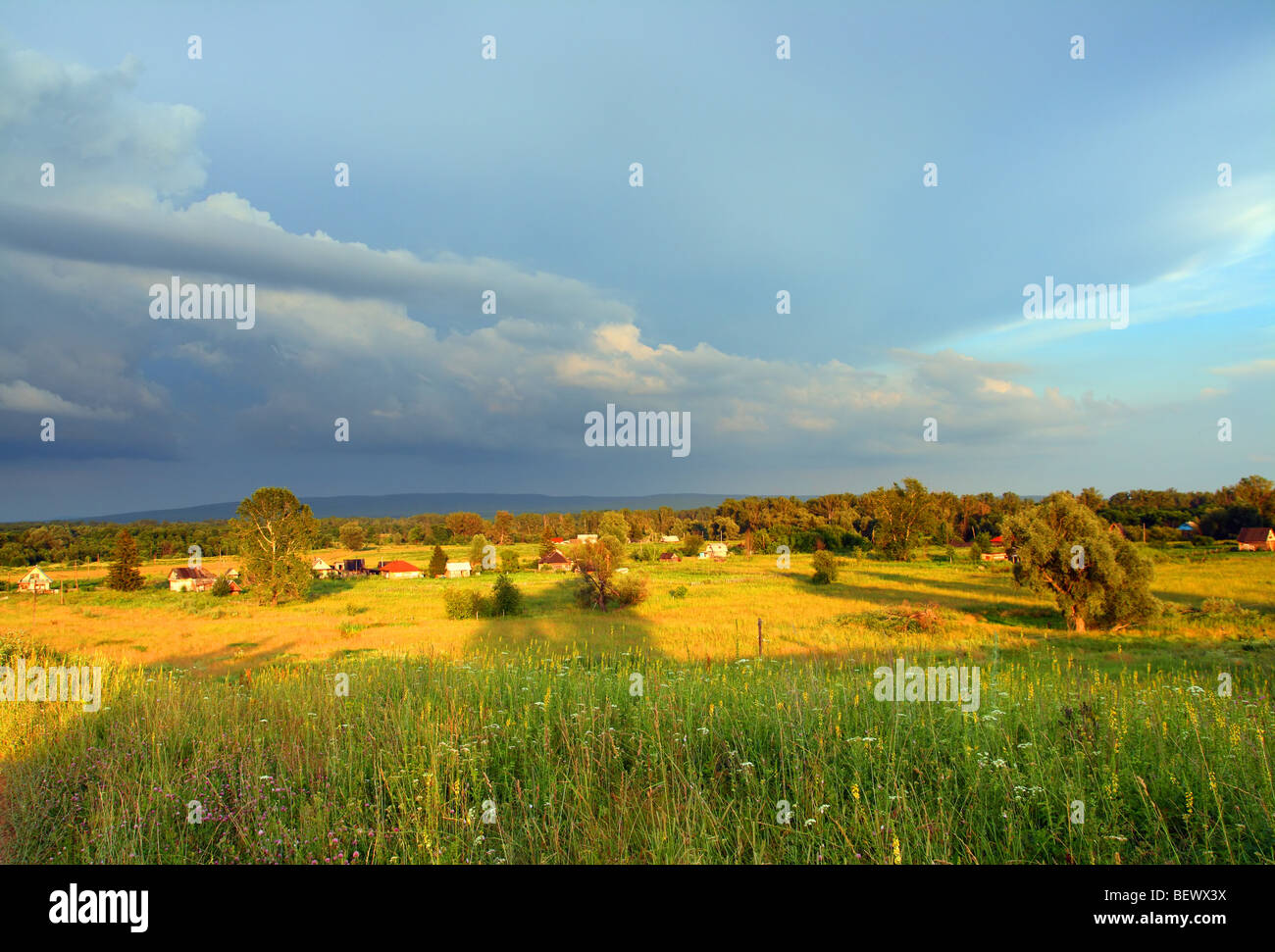 summer landscape with village valley under storm clouds Stock Photo - Alamy