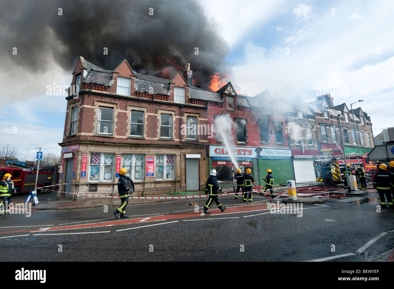 Row of shops on fire with flames coming through roof UK Stock Photo - Alamy
