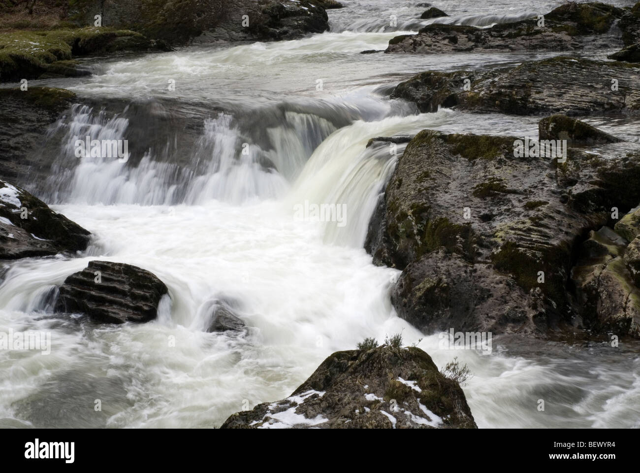 water flowing over rocks in fast flowing river Stock Photo - Alamy
