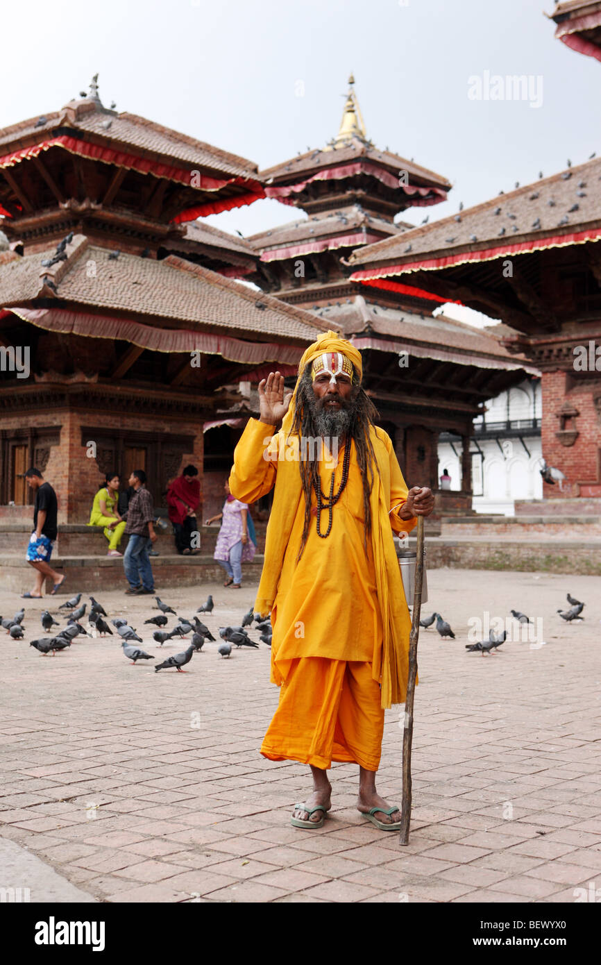 A Sadhu poses with raised hand in blessing at Kathmandu Durbar Square ...