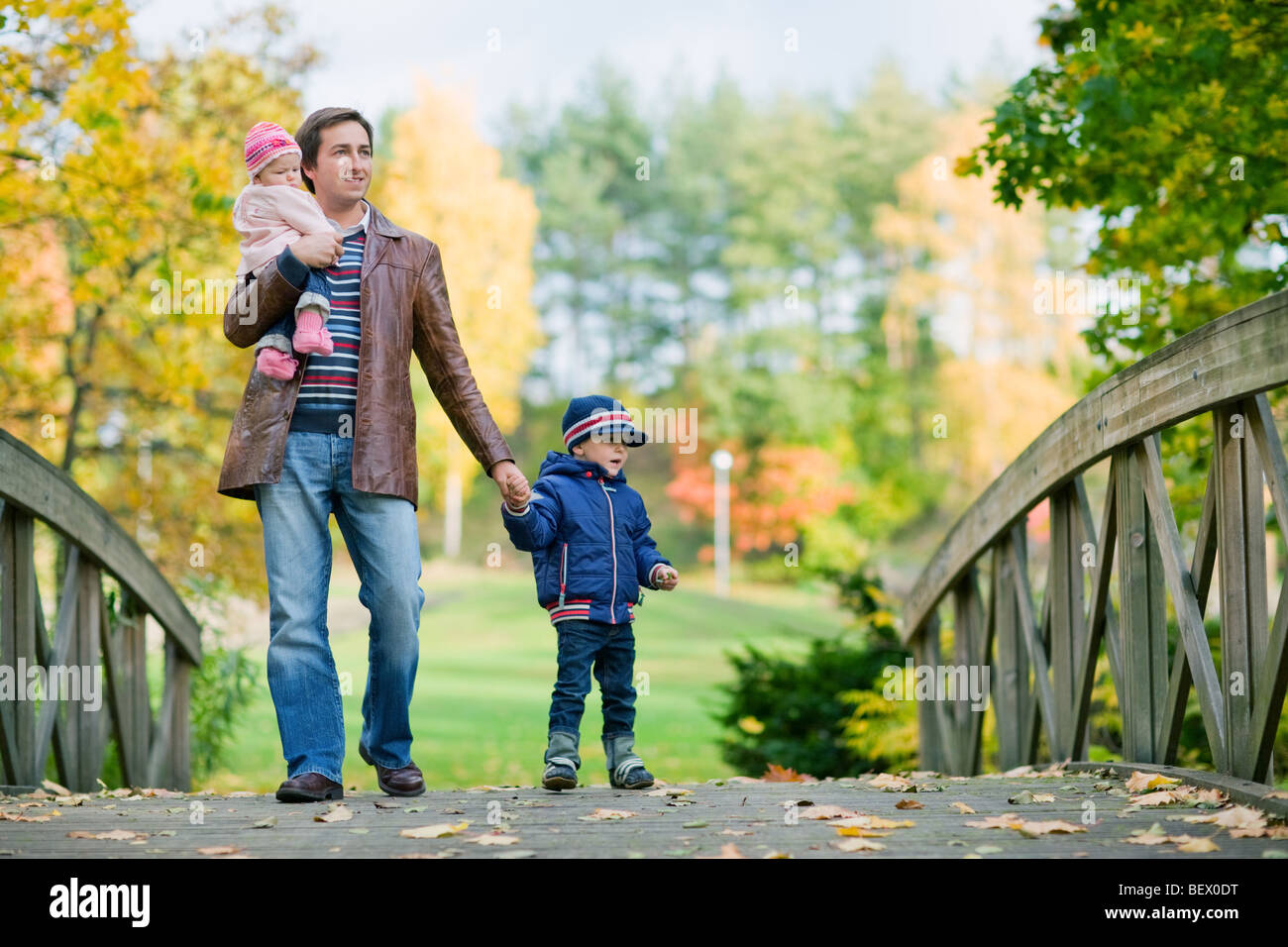 Young father with two kids enjoying beautiful autumn day Stock Photo ...