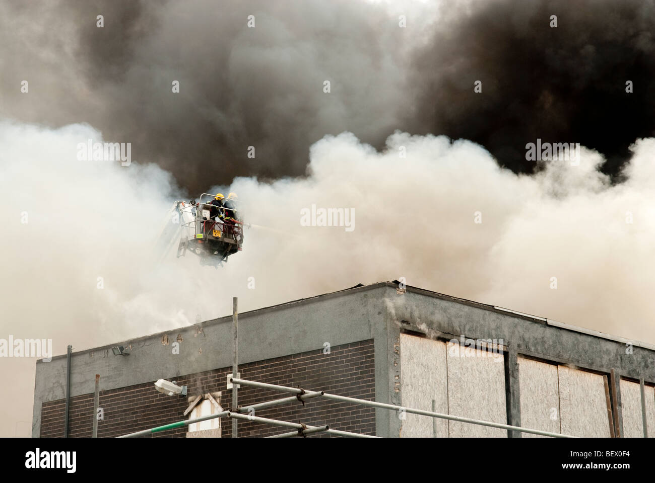 Factory fire with offices and flames and smoke coming from windows and ...