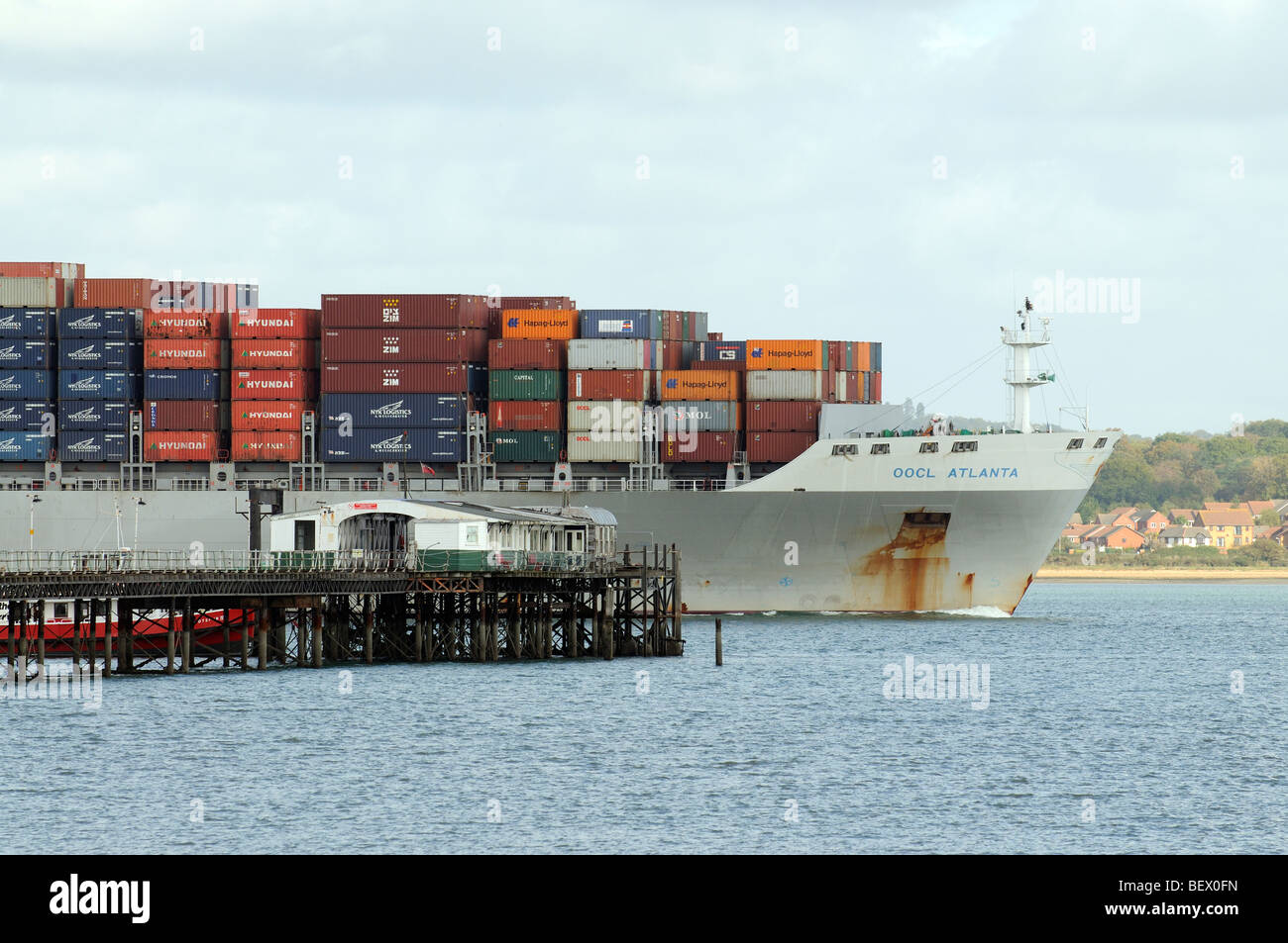 Container ship passing pier hi-res stock photography and images - Alamy