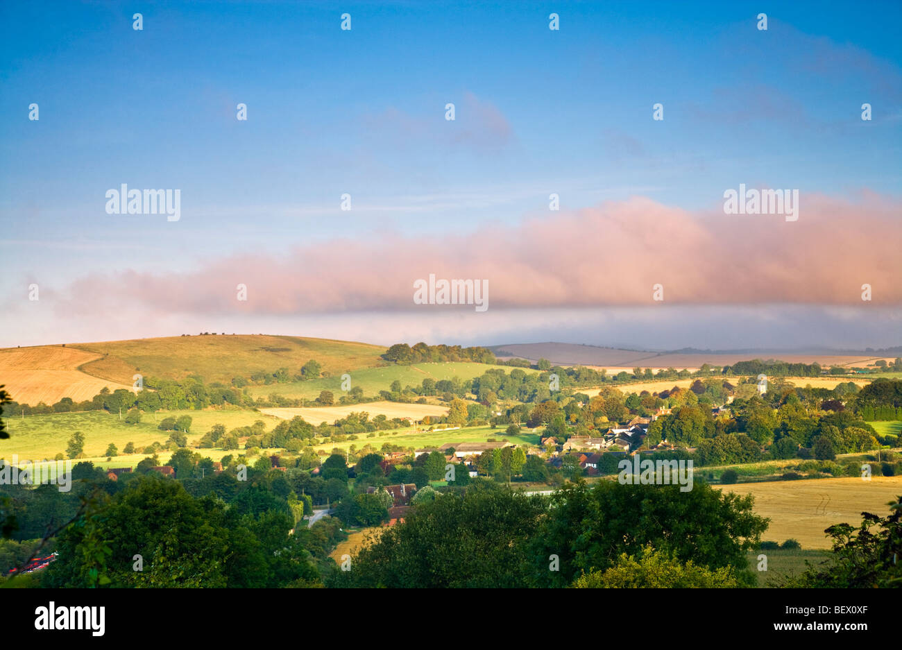 A typical early morning English countryside view over rolling fields ...