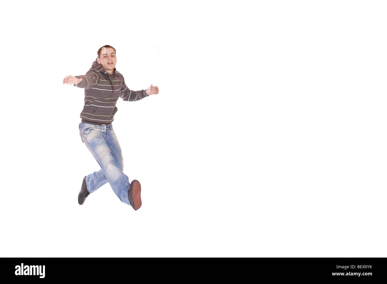 A handsome young man jumping isolated on white Stock Photo - Alamy