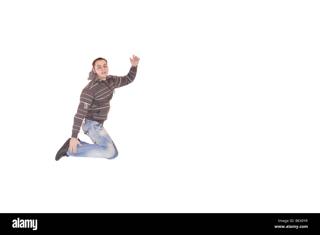 A handsome young man jumping isolated on white Stock Photo - Alamy