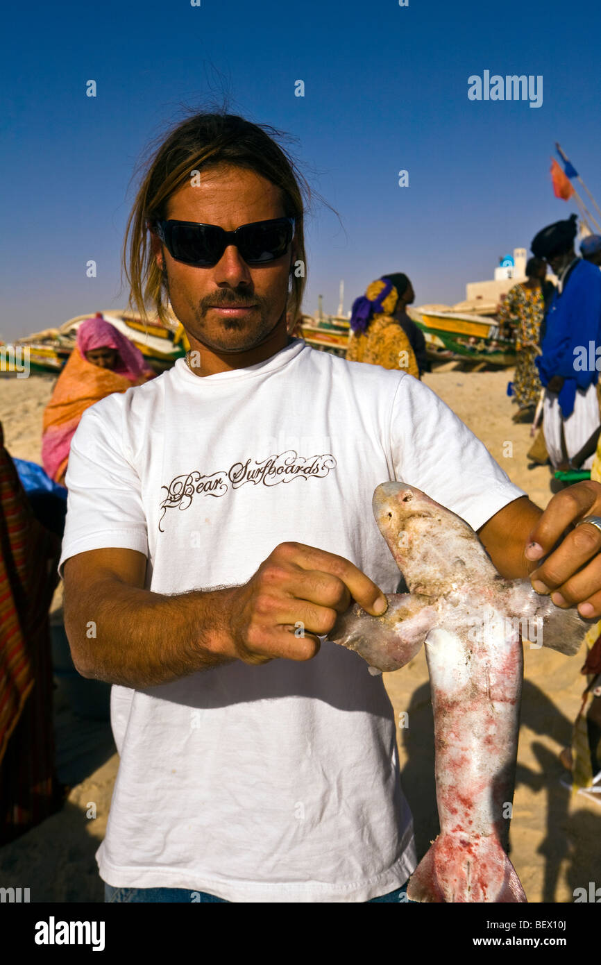 Mauritania, Nouakchott, fish market, man with shark Stock Photo - Alamy