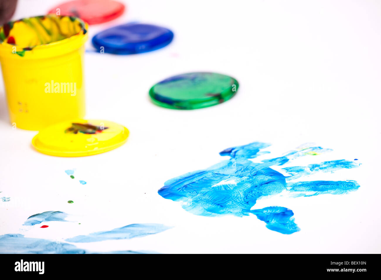 Closeup of colorful finger paints over white background Stock Photo - Alamy