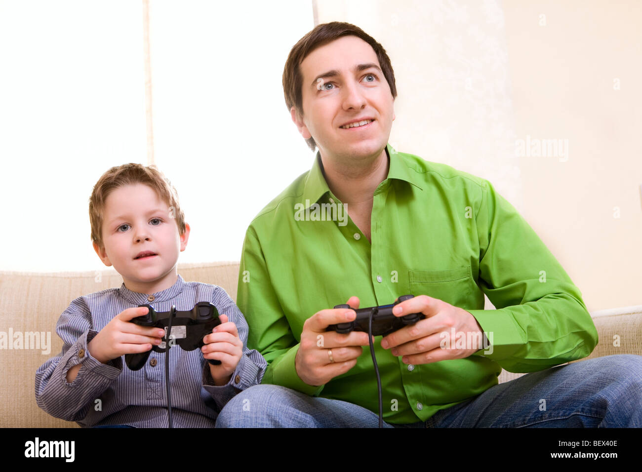 Father and son with video game controllers Stock Photo - Alamy
