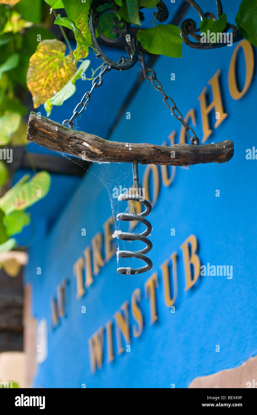 Large corkscrew hanging outside Alsace wine cellar inviting wine ...