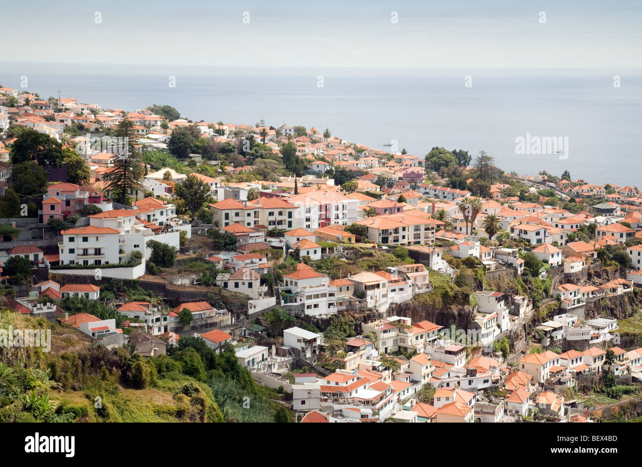 A view across the red tiled rooftops of Funchal, Madeira, to the sea ...
