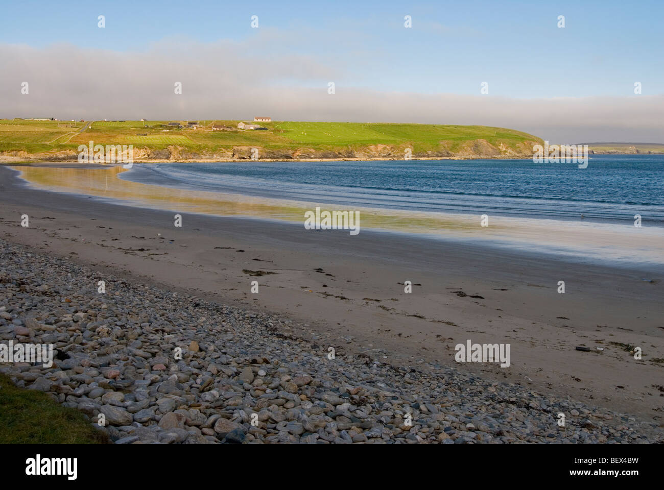 landscape view of tresta beach with sun on the water and shade on the ...