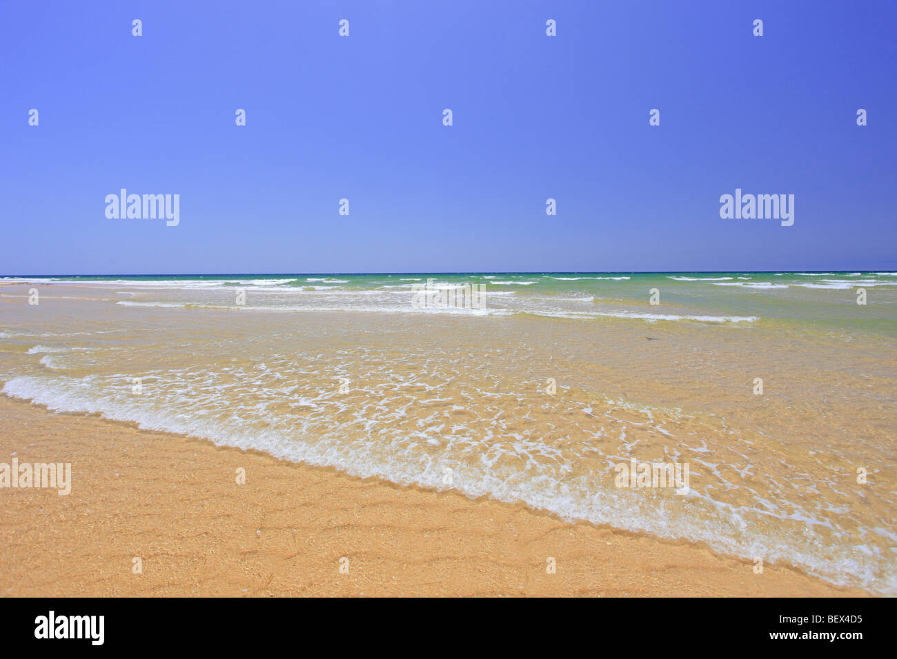 Sandy beach in Faro, Portugal Stock Photo - Alamy