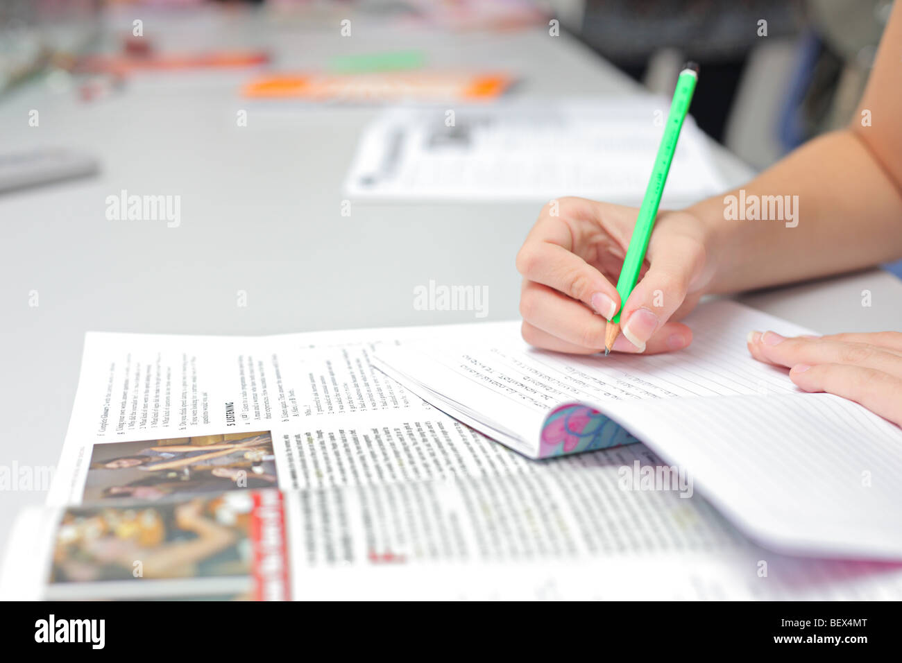 Student writing in a notebook Stock Photo - Alamy