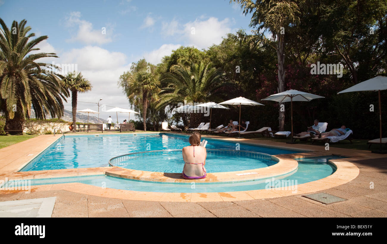 A woman reading a book in the hotel swimming pool, Quinta da Bela Vista ...