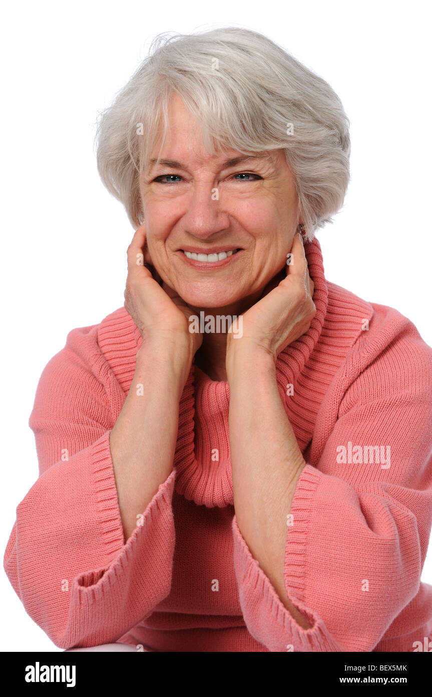 Senior citizen woman with hands on face smiling Stock Photo - Alamy