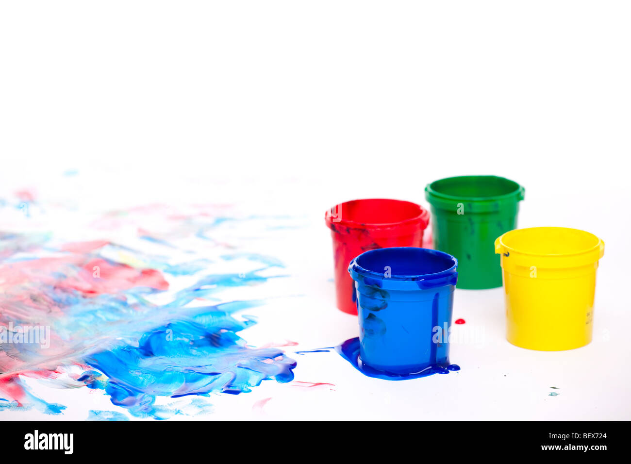 Closeup of colorful finger paints over white background Stock Photo - Alamy