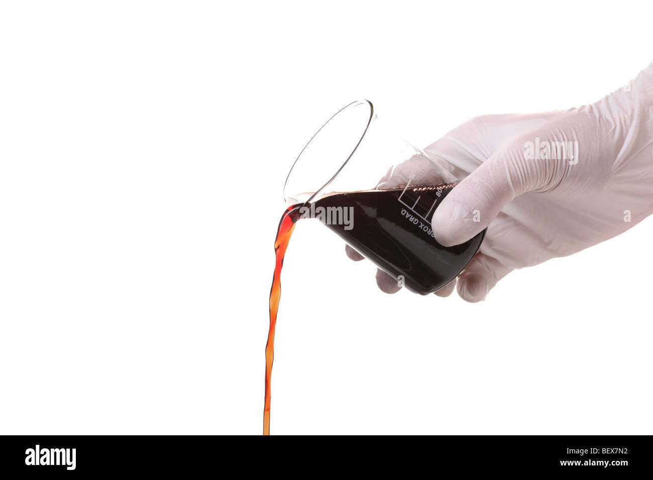 Gloved hand pouring liquid Stock Photo - Alamy