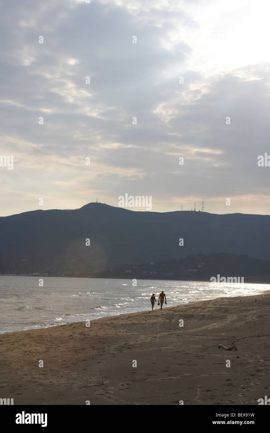 People walking on a beach Stock Photo - Alamy