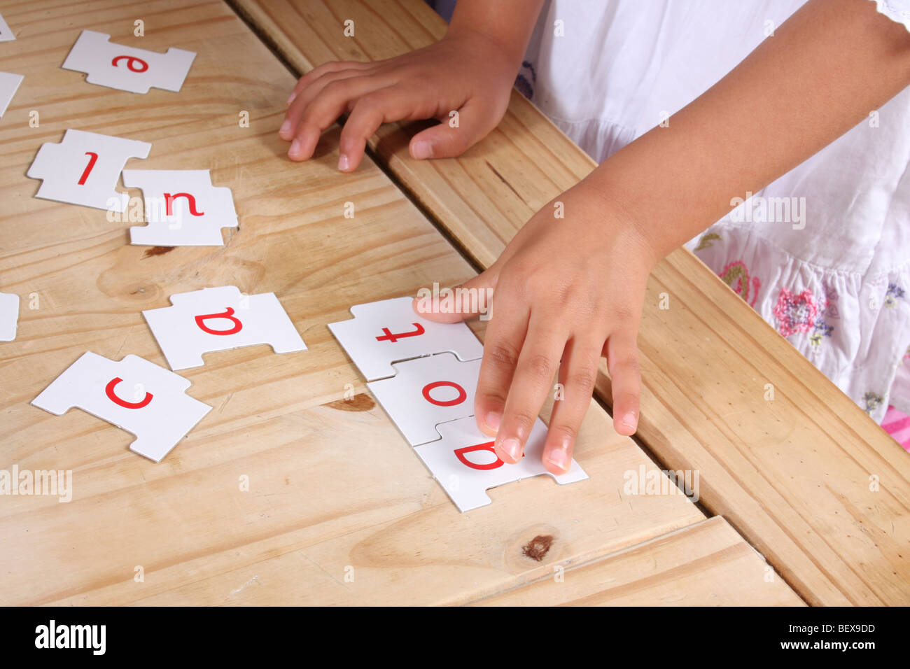 A child's hand preparing letters to make a word Stock Photo - Alamy