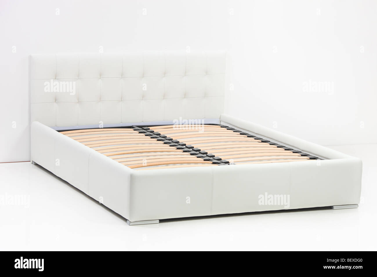 A view of a modern bed in an empty room Stock Photo - Alamy