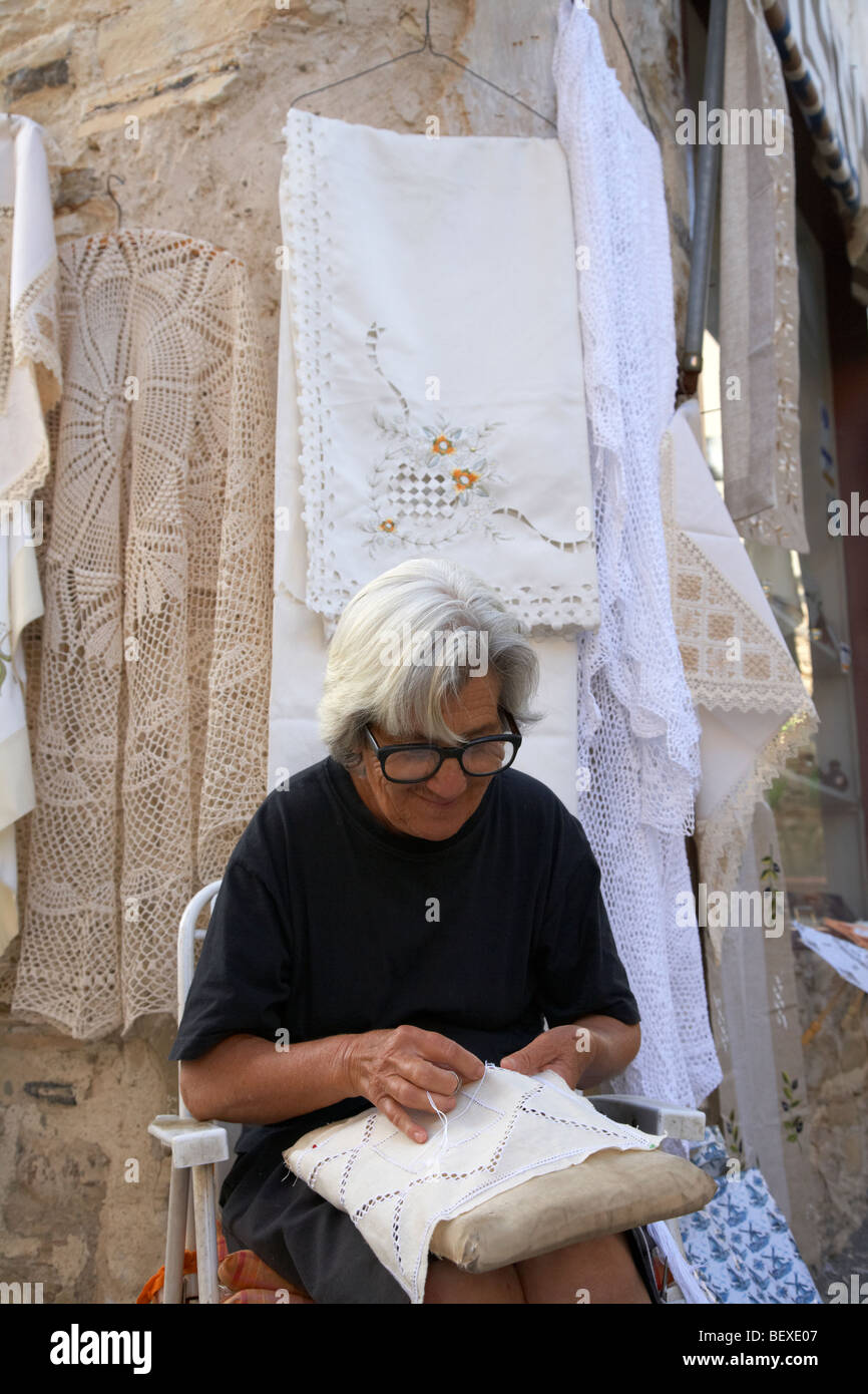 old grey haired widow sewing traditional lace hand made outside the ...