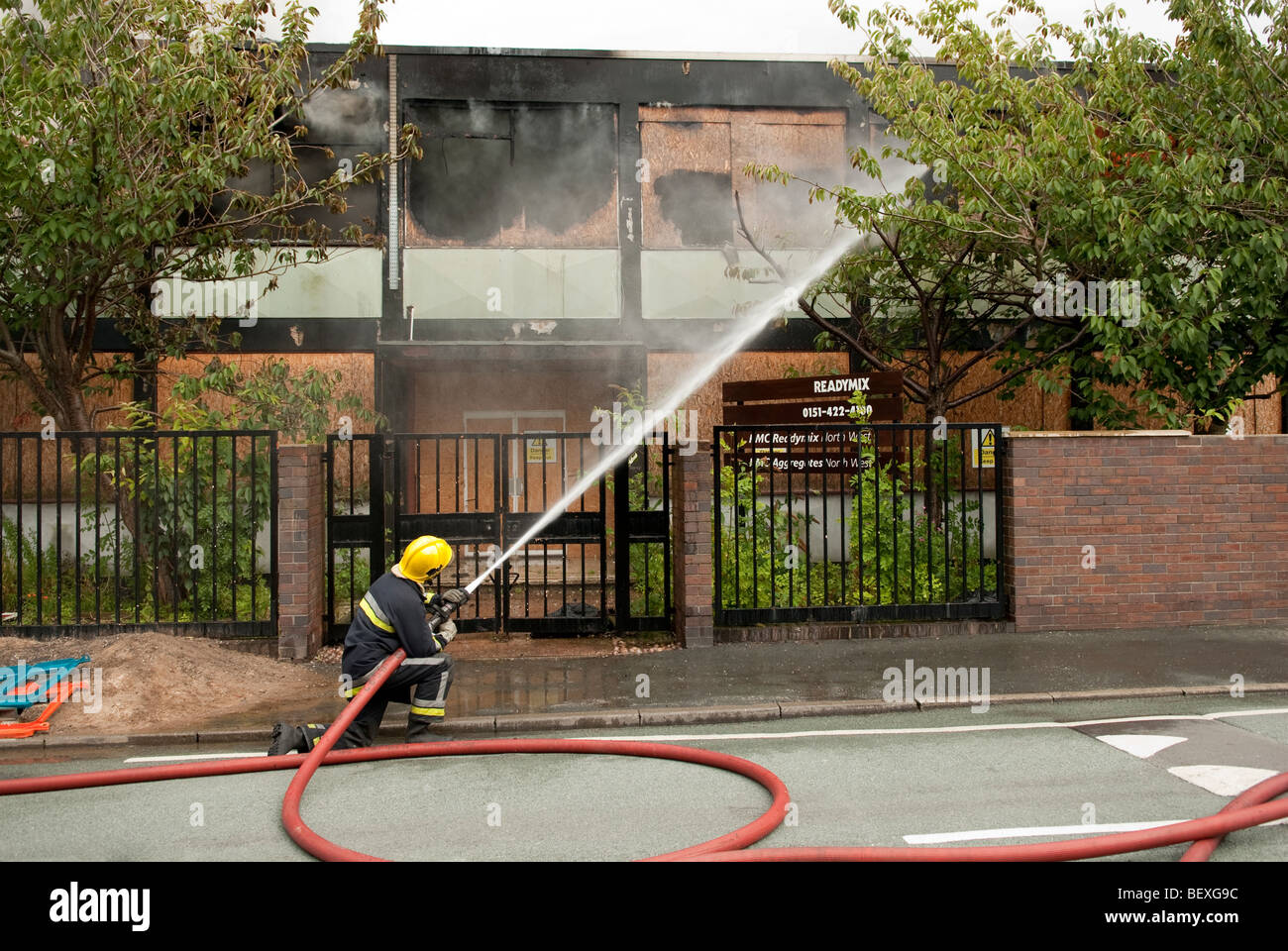 Factory fire with offices and flames and smoke coming from windows and ...