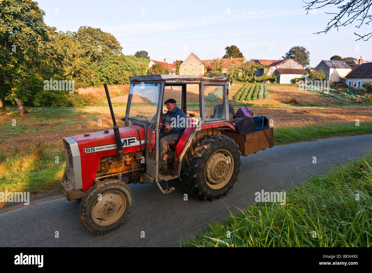 French peasant farmer driving old tractor along narrow lane - sud ...