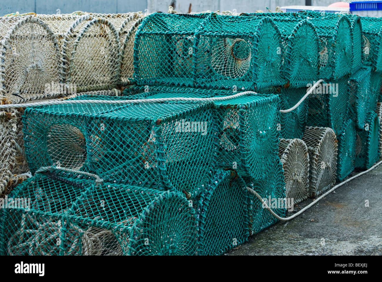 Green and white empty lobster pots stored on a Scottish jetty Stock ...