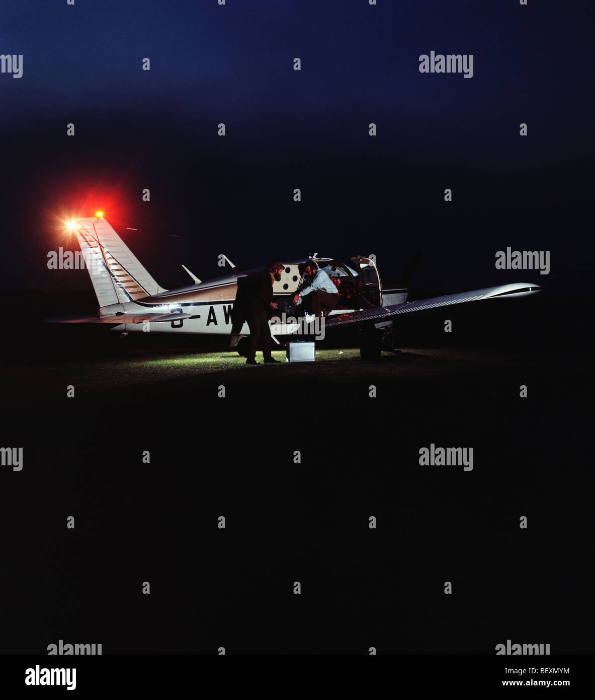 Loading Piper Cherokee Arrow Aircraft for a night flight Stock Photo ...