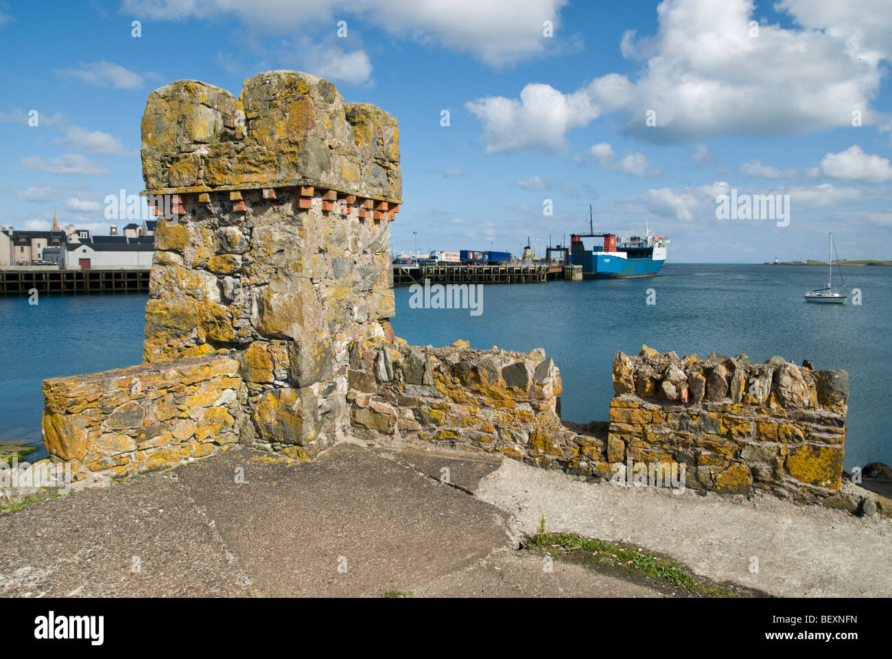 View with old stone wall looking across Stornoway harbour, Isle of ...